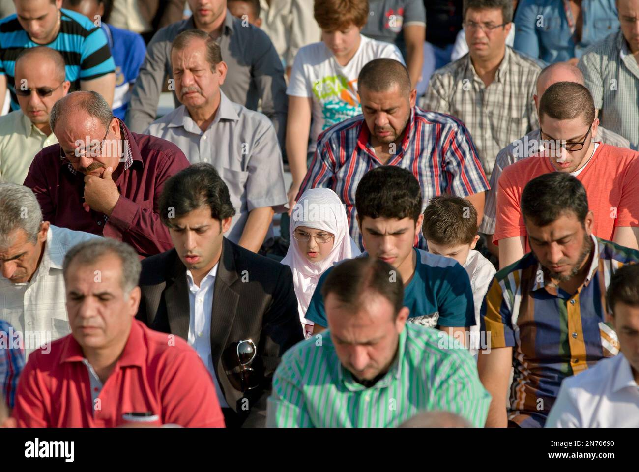 A girl takes part alongside men in Eid al-Fitr prayers in Bucharest ...