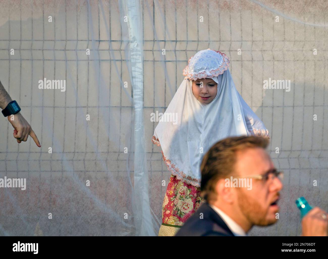 Sara, 4 years-old, reacts before Eid al-Fitr prayers in Bucharest ...