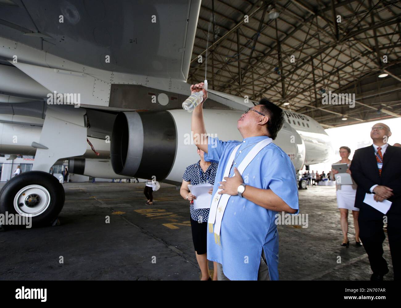 A Roman Catholic priest blesses with holy water the brand new Airbus ...
