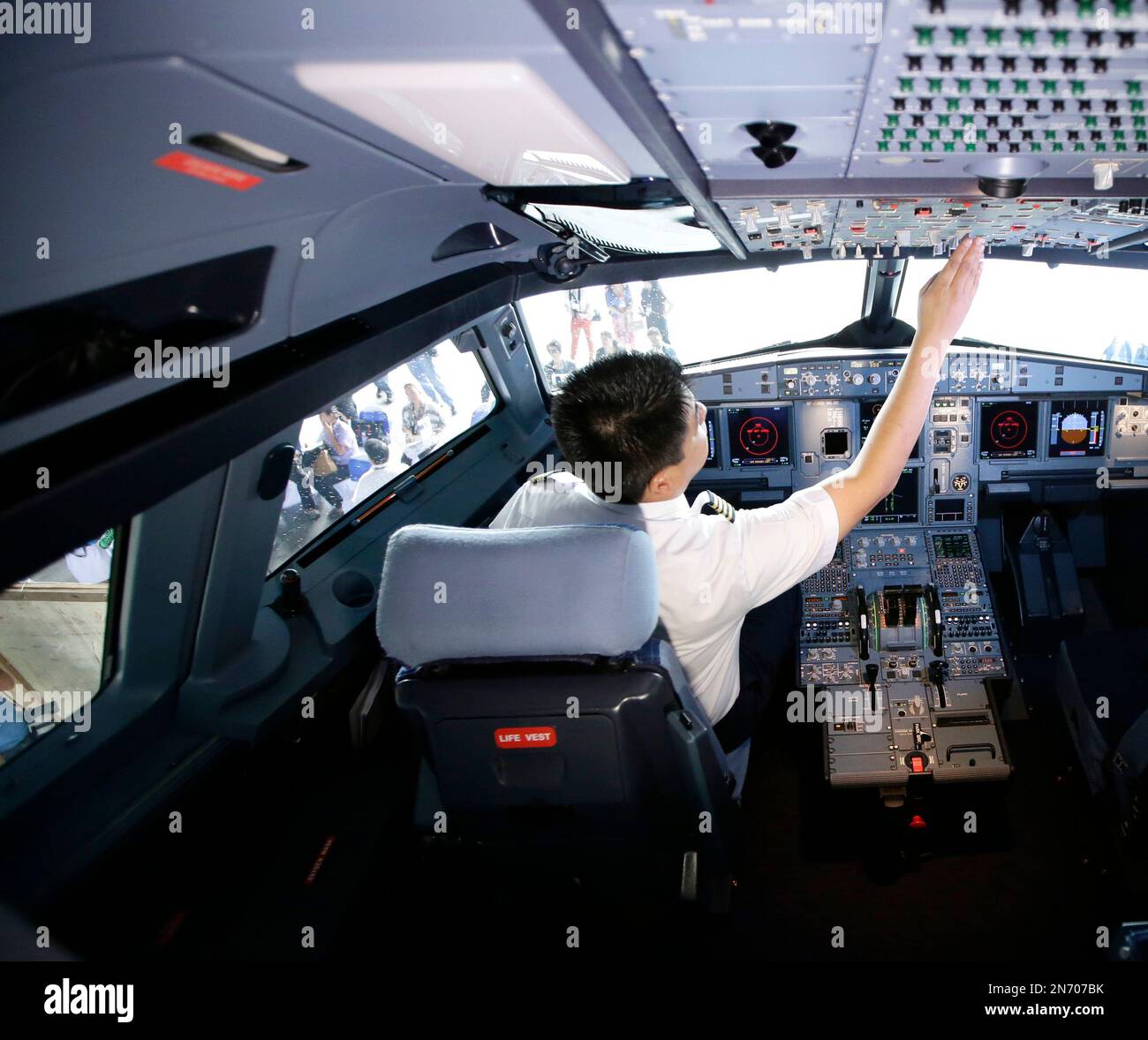 A pilot checks the controls in the cockpit of the brand new Airbus A321 ...