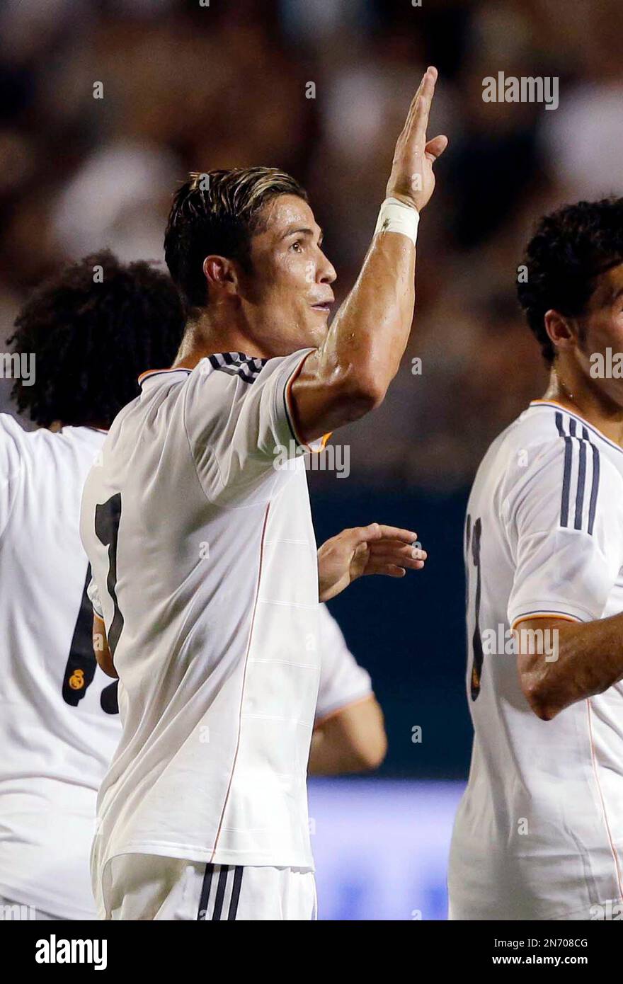 Real Madrid forward Cristiano Ronaldo raises his hand to the cheering ...