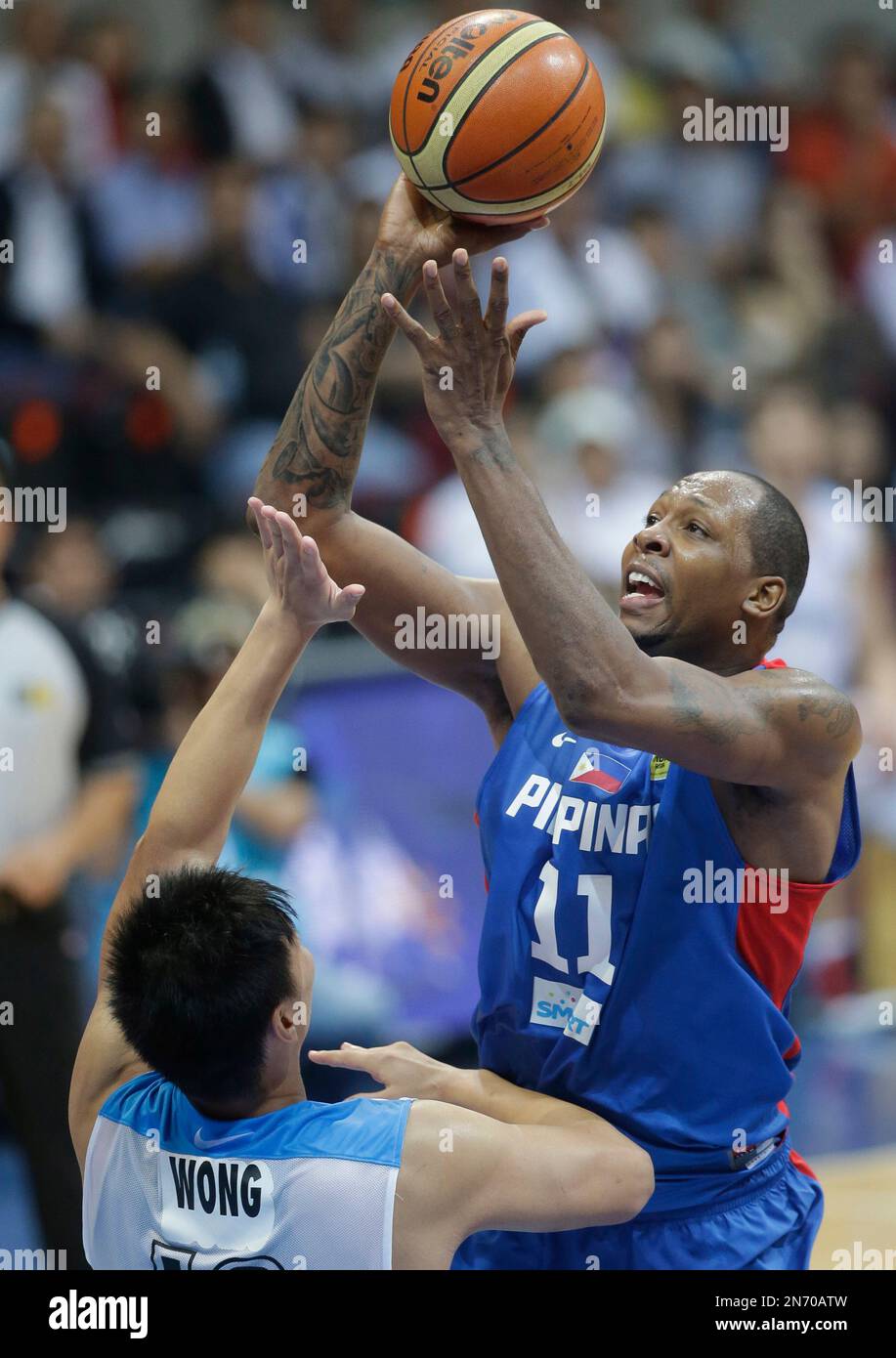 The Philippines Marcus Douthit, right, attempts a shot against Hong ...