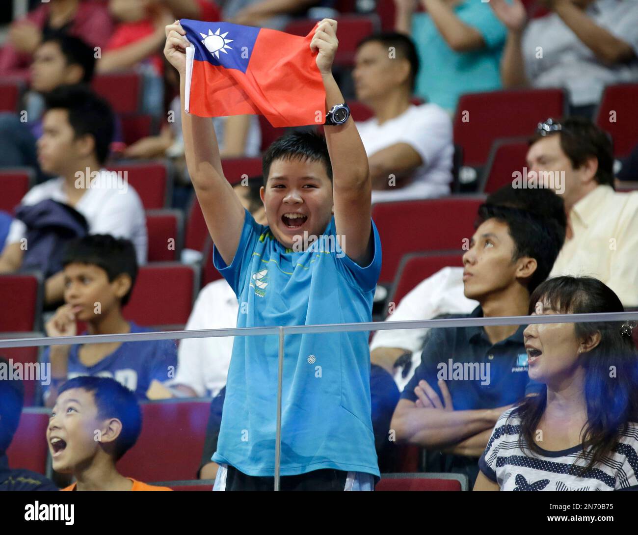 A fan waves a Taiwanese flag while cheering for Taiwan's basketball ...