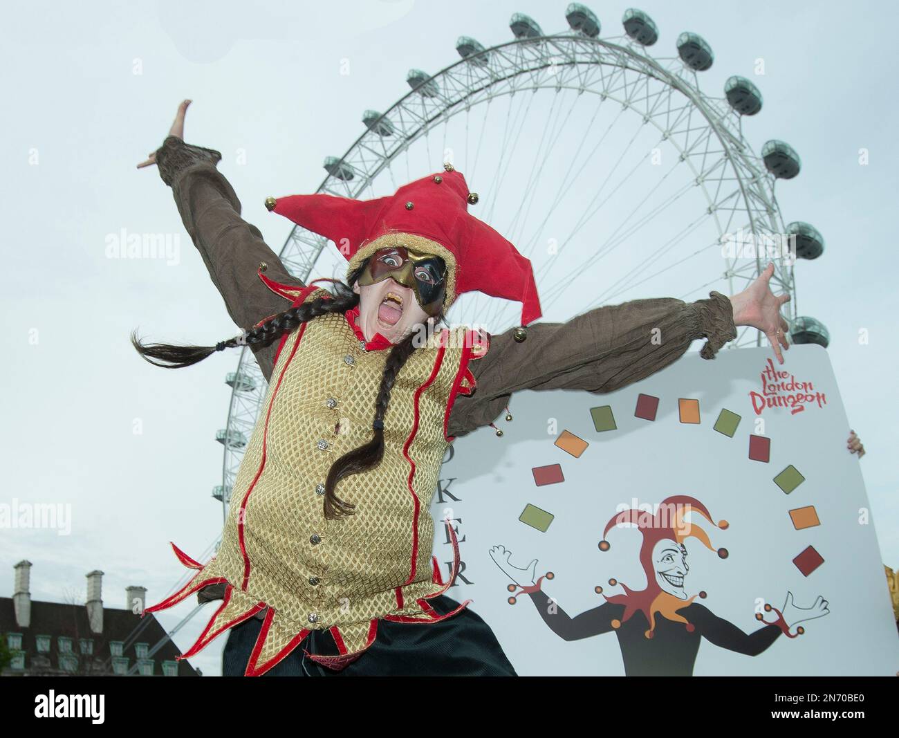 Jesters from the London Dungeon perform in front of a giant joker as ...