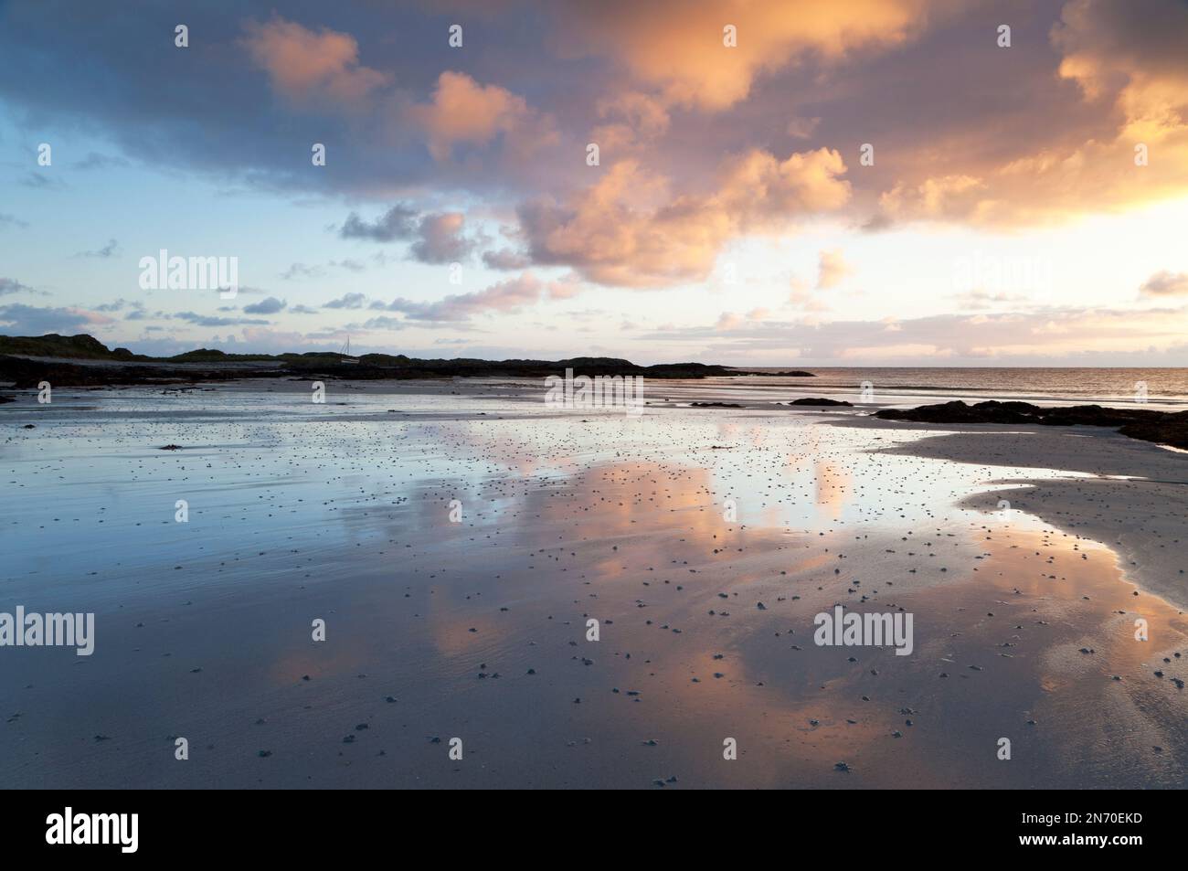 Reflected light on the beach near Cornaigmore, on the Isle of Tiree in ...