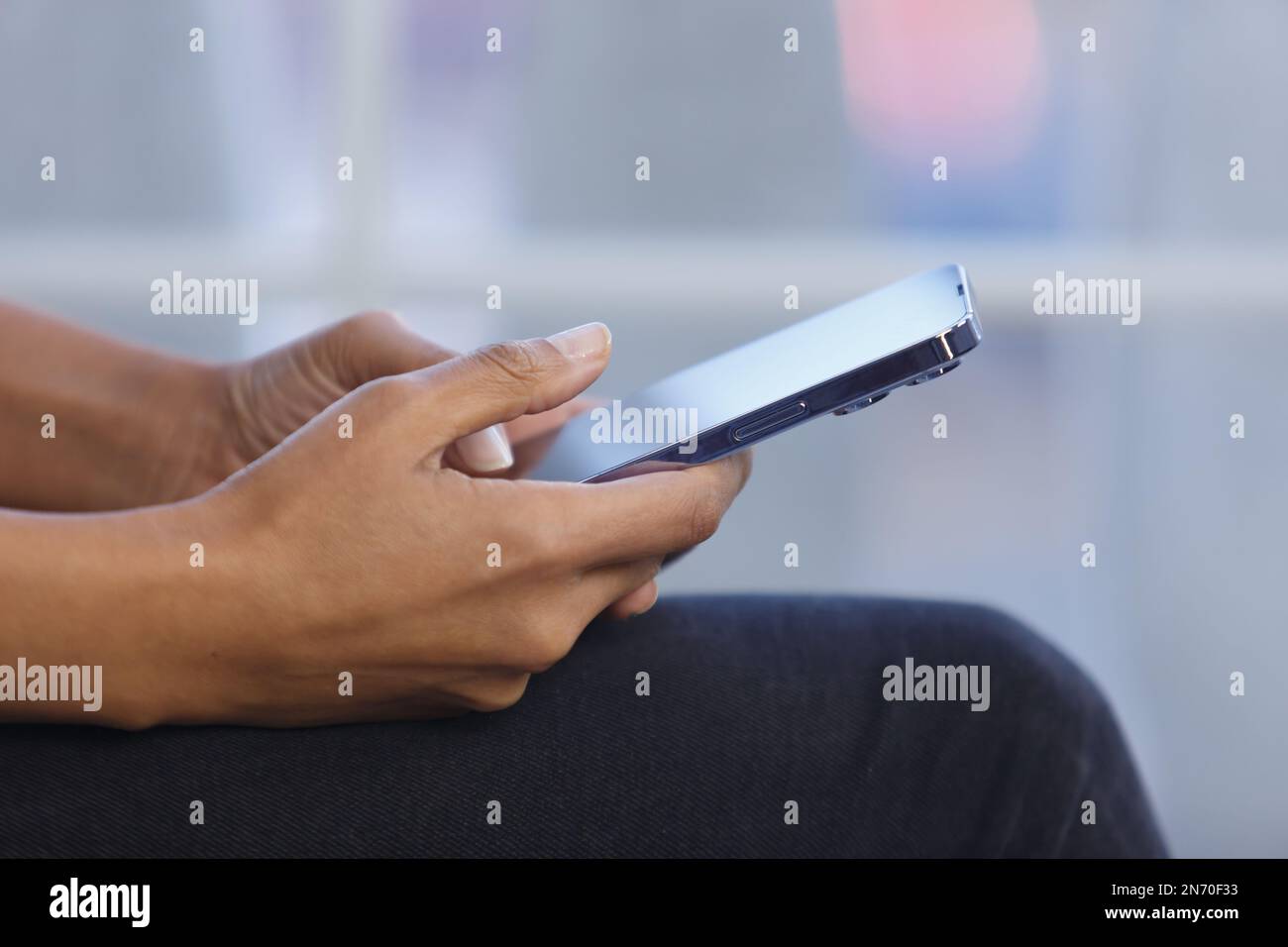 Hands of black female person typing a message on smart phone. Young ...
