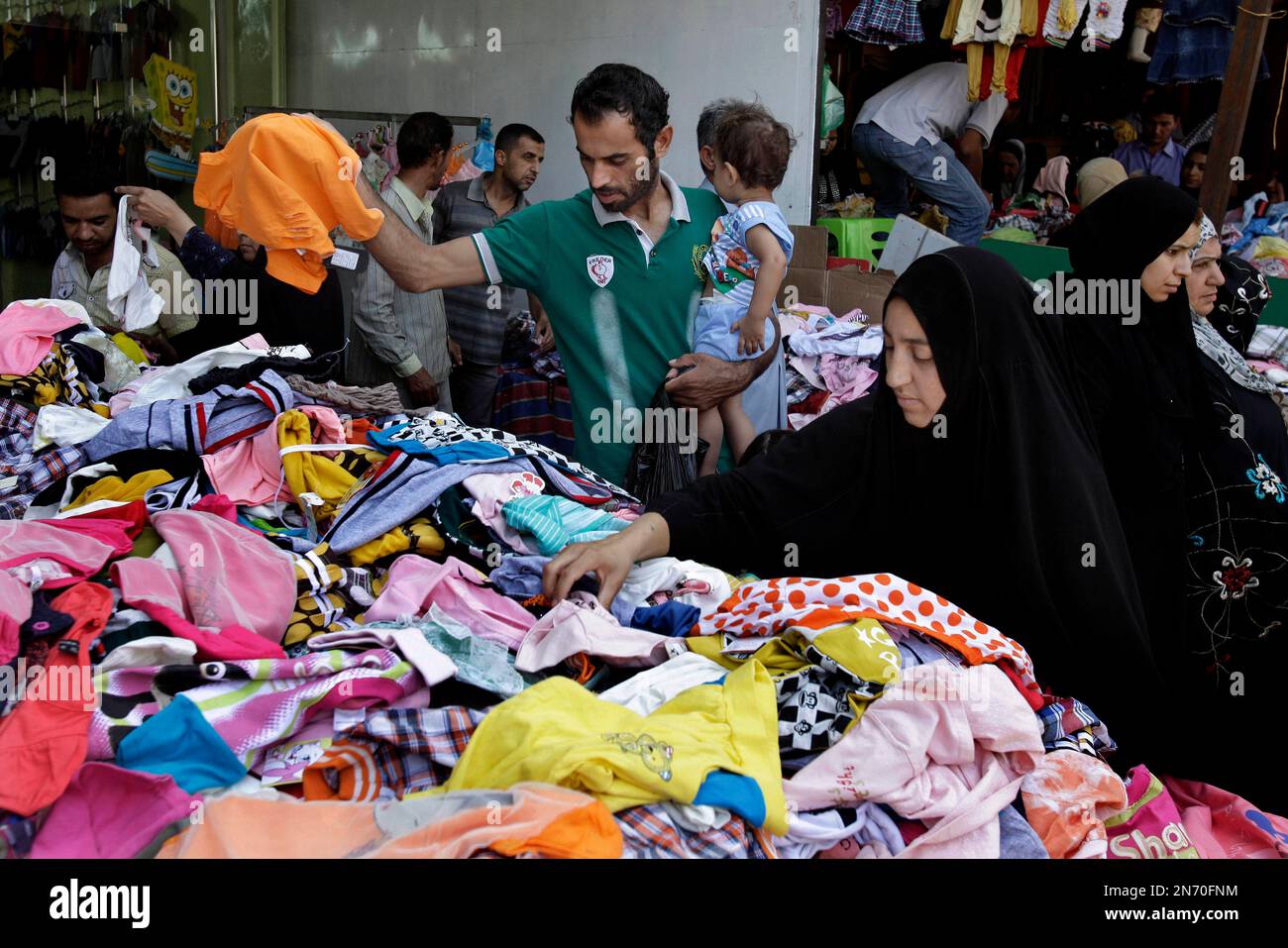 Iraqis buy clothes for Eid al-Fitr at the Shorjah market in central ...