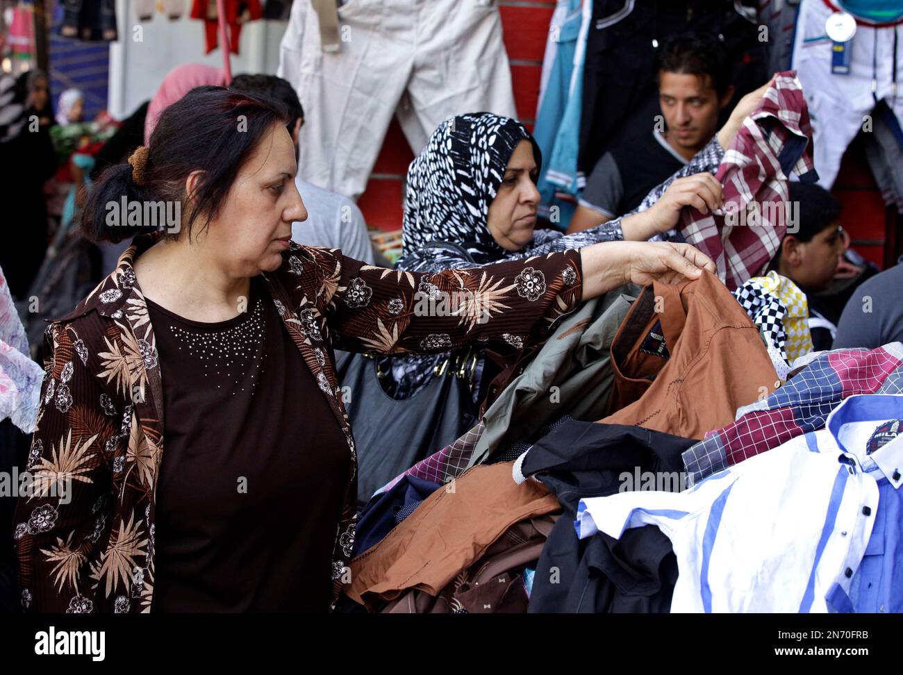 Iraqis buy clothes for Eid al-Fitr at the Shorjah market in central ...