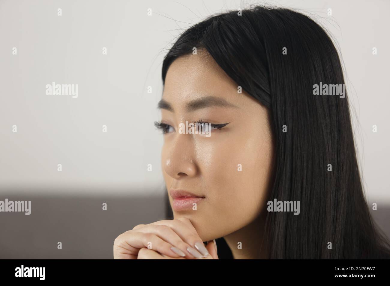 Portrait of beautiful Asian girl looking away in thought. Attractive ...