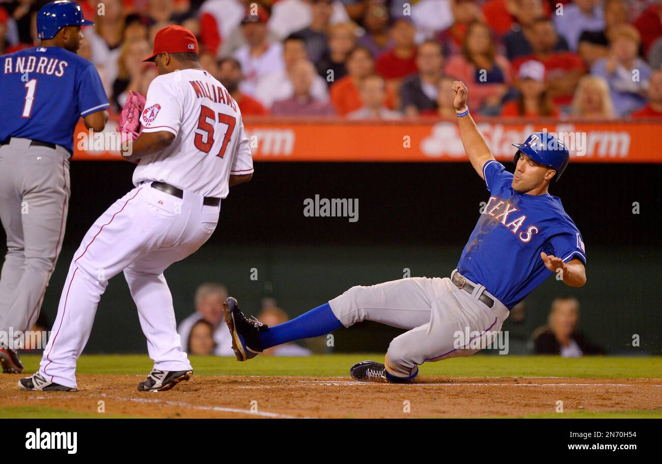 Texas Rangers' David Murphy, right, scores on a wild pitch at Los ...