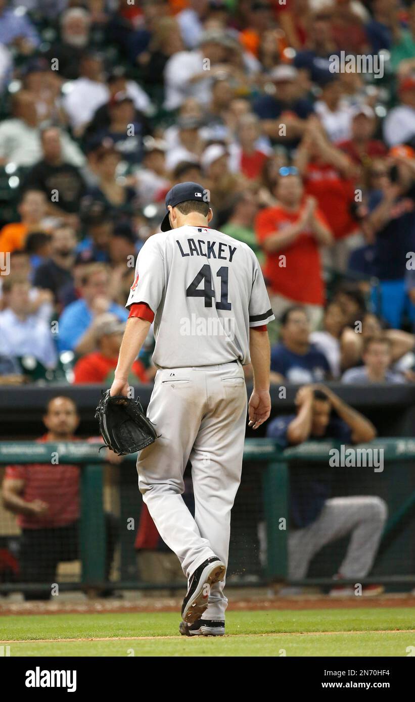 Boston Red Sox starting pitcher John Lackey heads to the dugout after ...