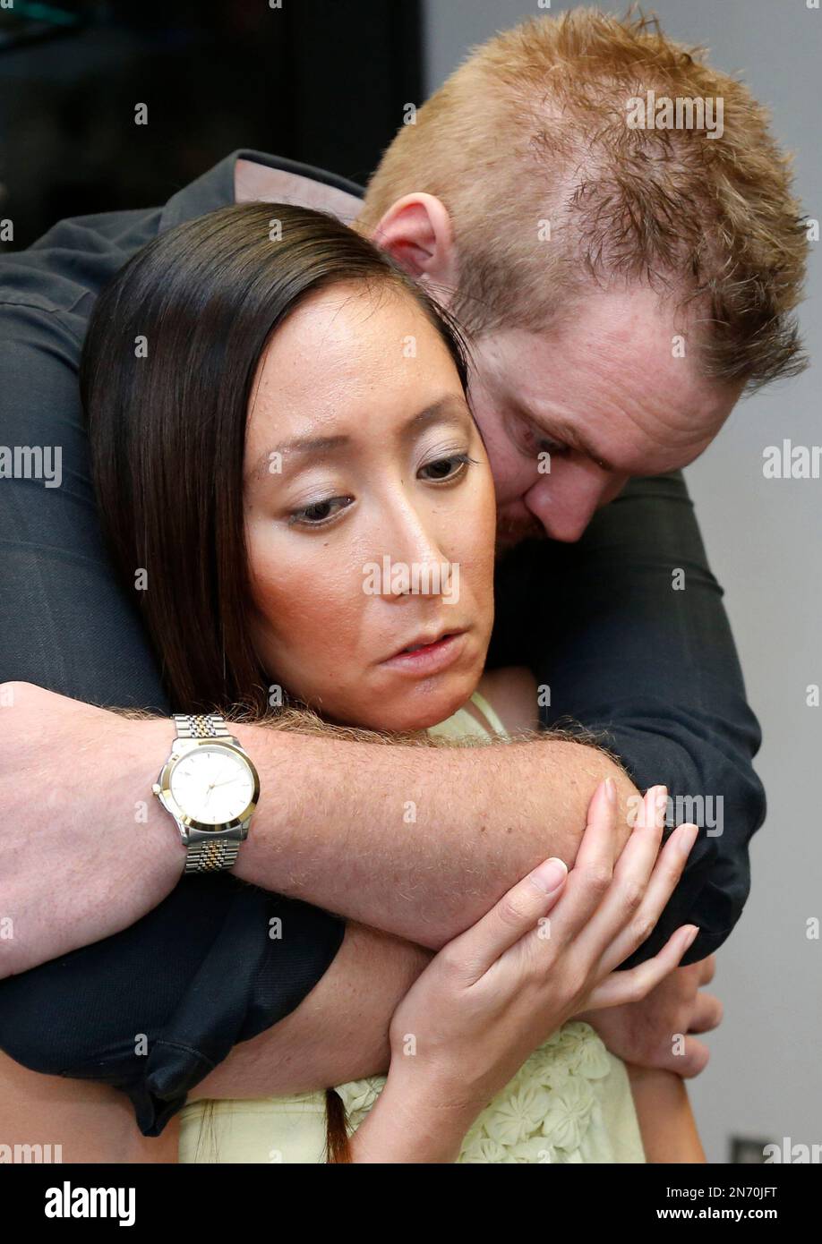 In this Wednesday, July 31, 2013 photo, Nyle Rogers, right, embraces ...
