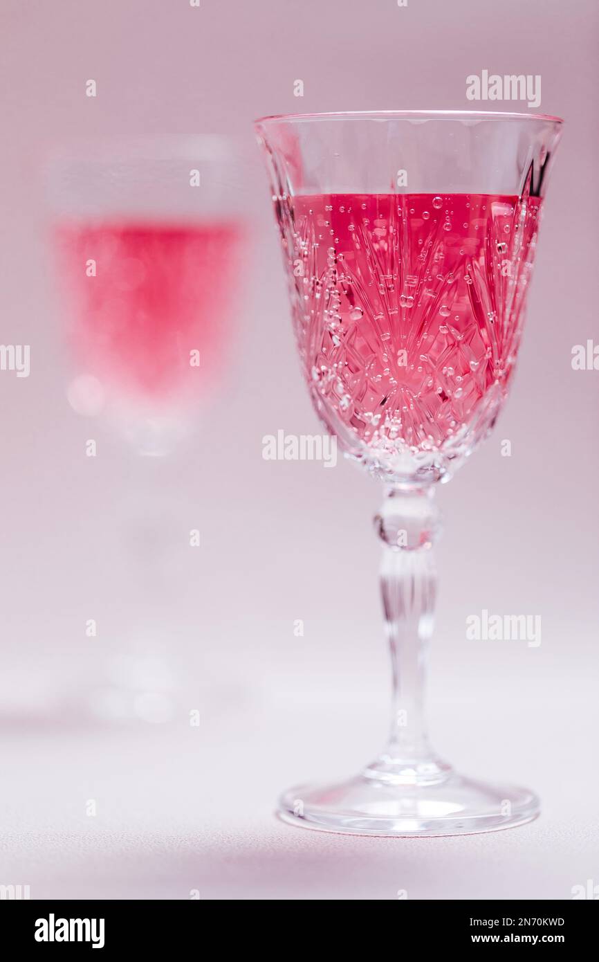 Couple holding two pink cocktails for Valentine's day celebration. Love ...