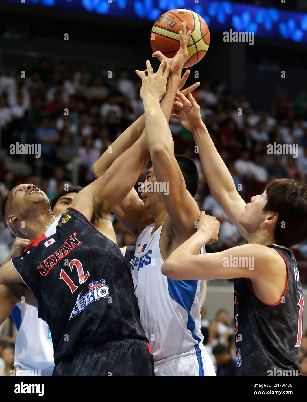 Japan's JR Sakuragi (12) and teammate Ryota Sakurai, right, try to wrest control of the ball ...