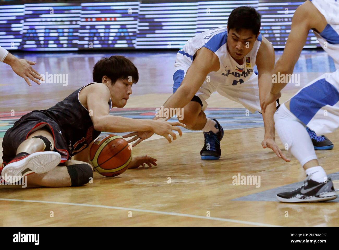 Japan's Ryota Sakurai, left, and the Philippines' Ranidel de Ocampo, battle for a loose ball in ...