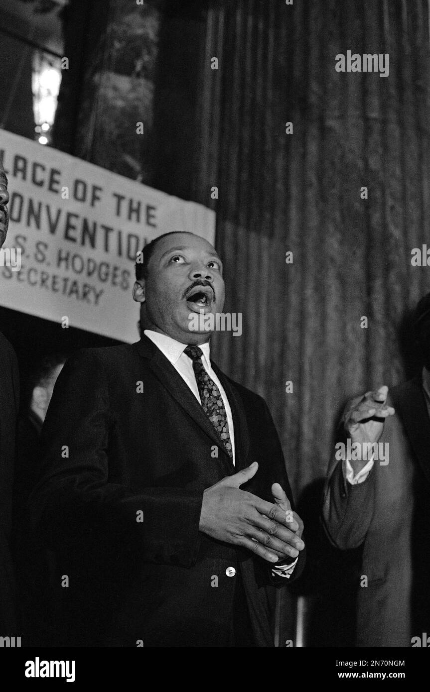 FILE-This file photo shows the Rev. Martin Luther King Jr. joining in ...