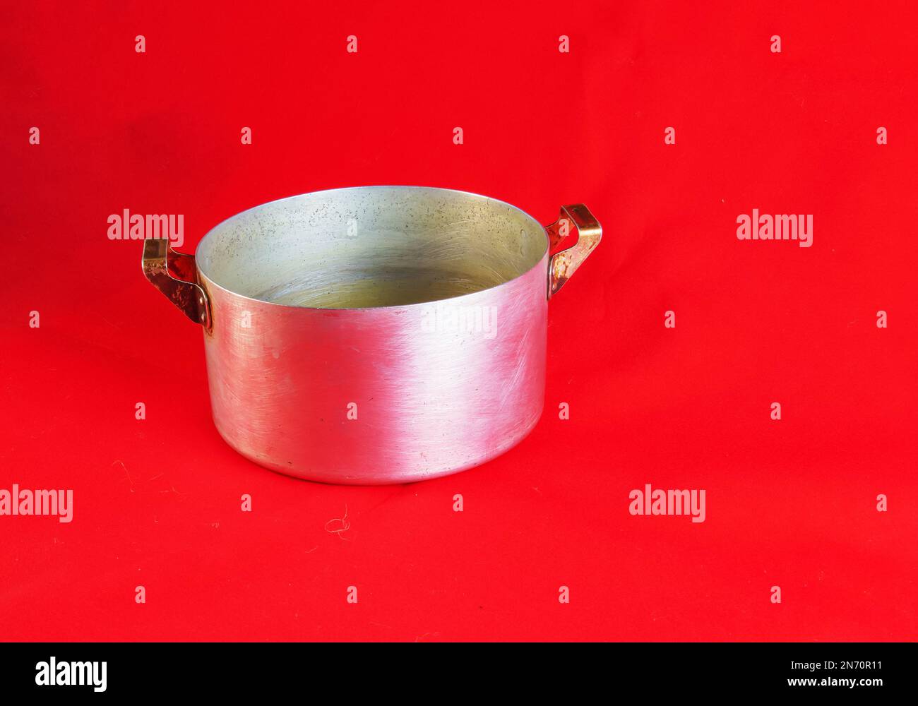 An old aluminum pan made in circa 1960 against a red background Stock ...
