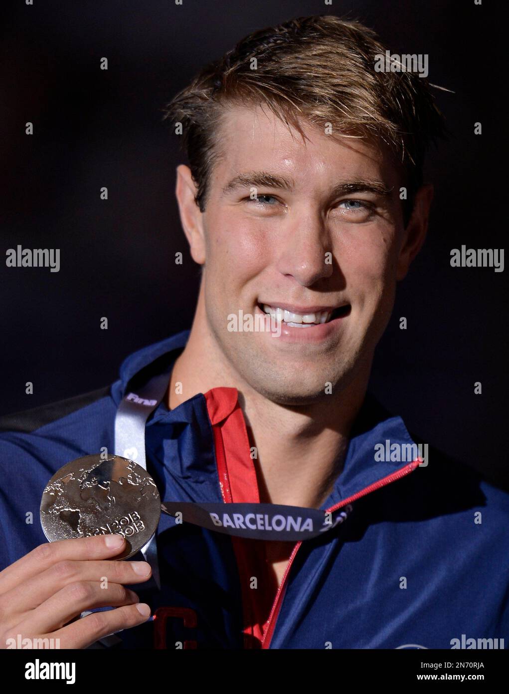 Matt Grevers of the United States smiles as he holds the bronze medal ...