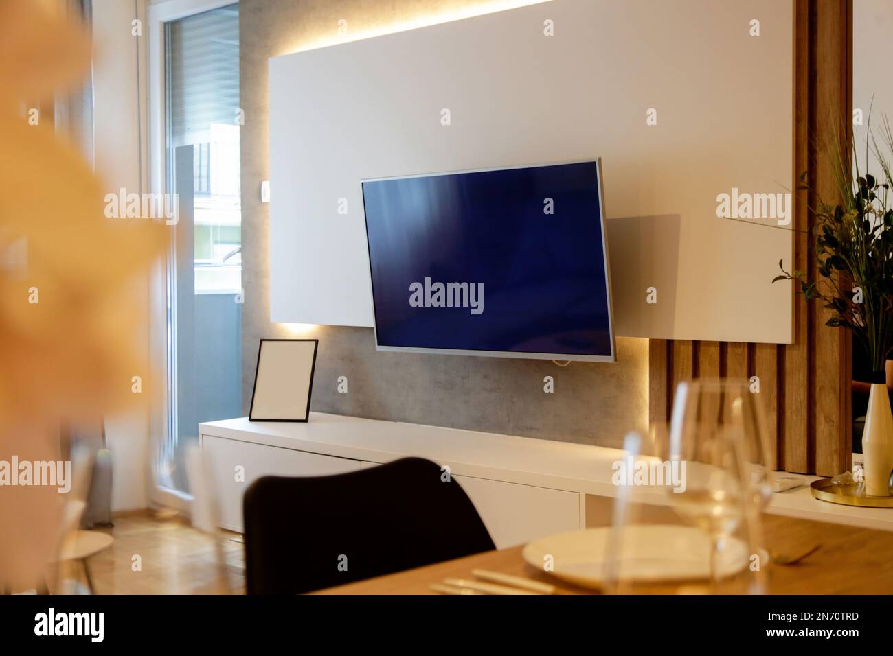 Living room with big tv hanging on a decorative wall Stock Photo - Alamy