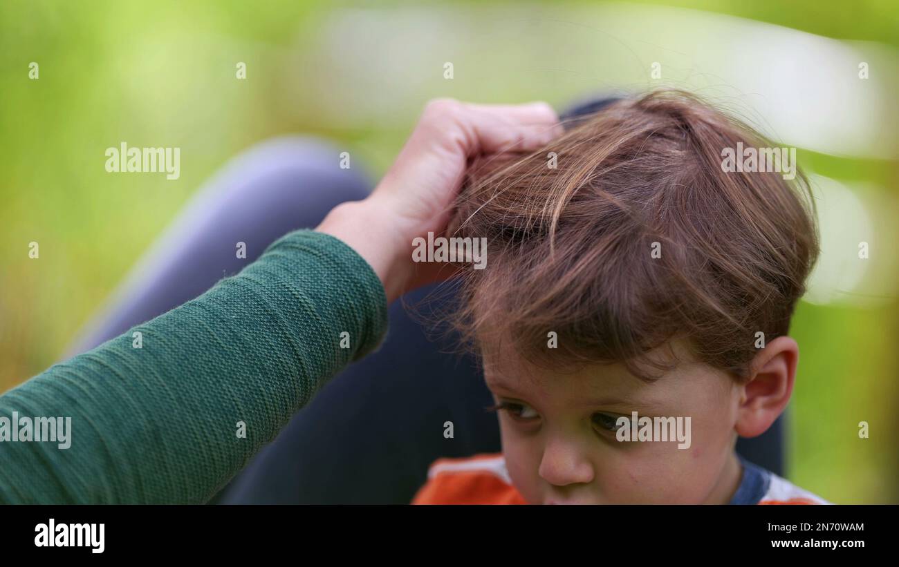 Mother caressing child hair. Parent showing love and affection to ...