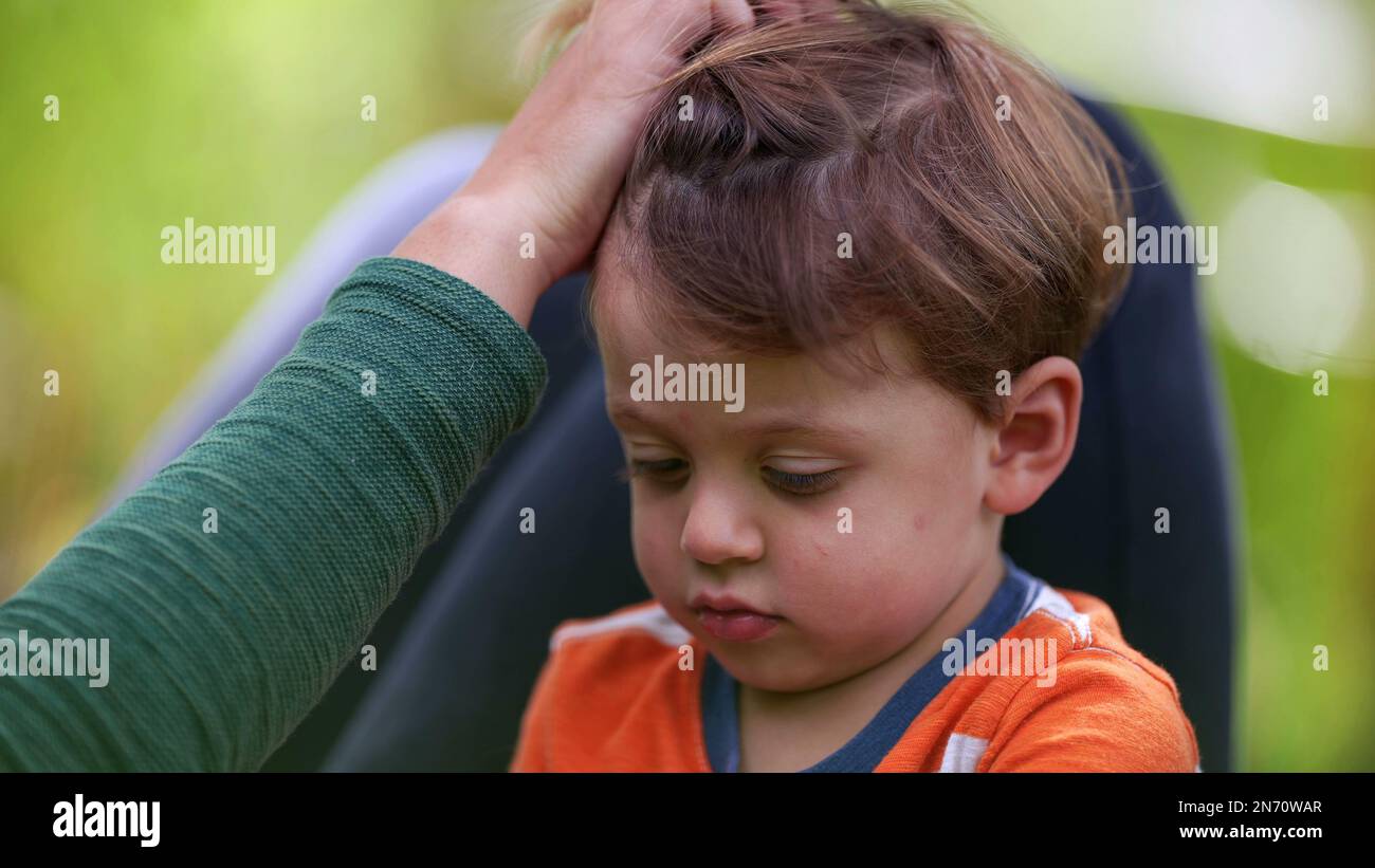 Mother caressing child hair. Parent showing love and affection to ...