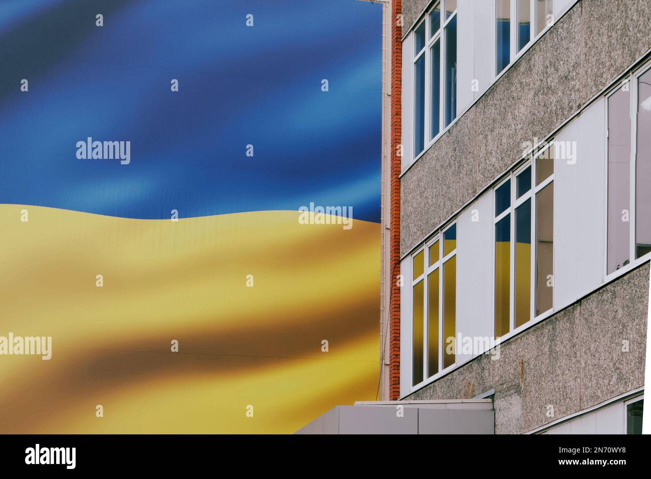 A giant Ukrainian flag stretched across the side of the building ...