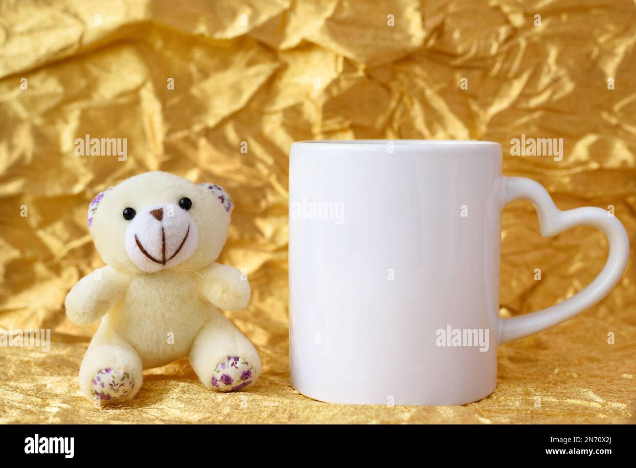 Mockup white blank mug with Teddy bear on golden background, copyspace ...