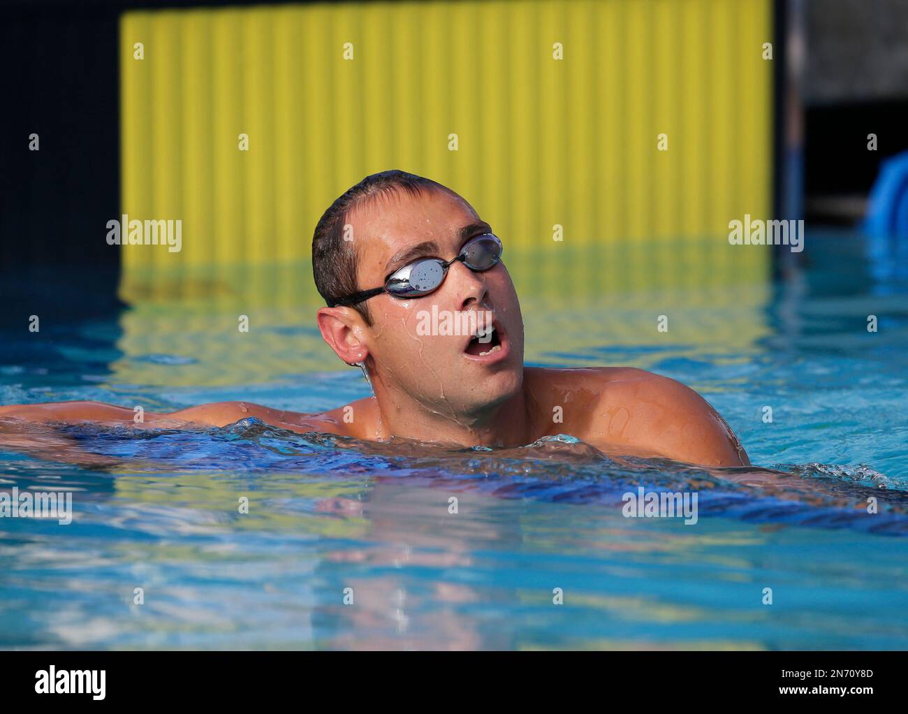 Gold medalist Mike Alexandrov looks at the scoreboard after competing ...