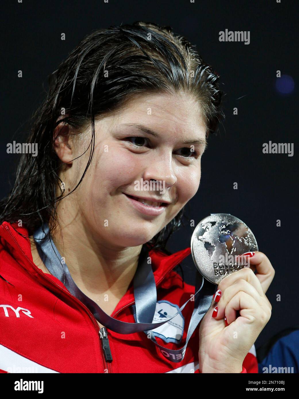 Denmark's Lotte Friis smiles as she holds the silver medal that shoe ...