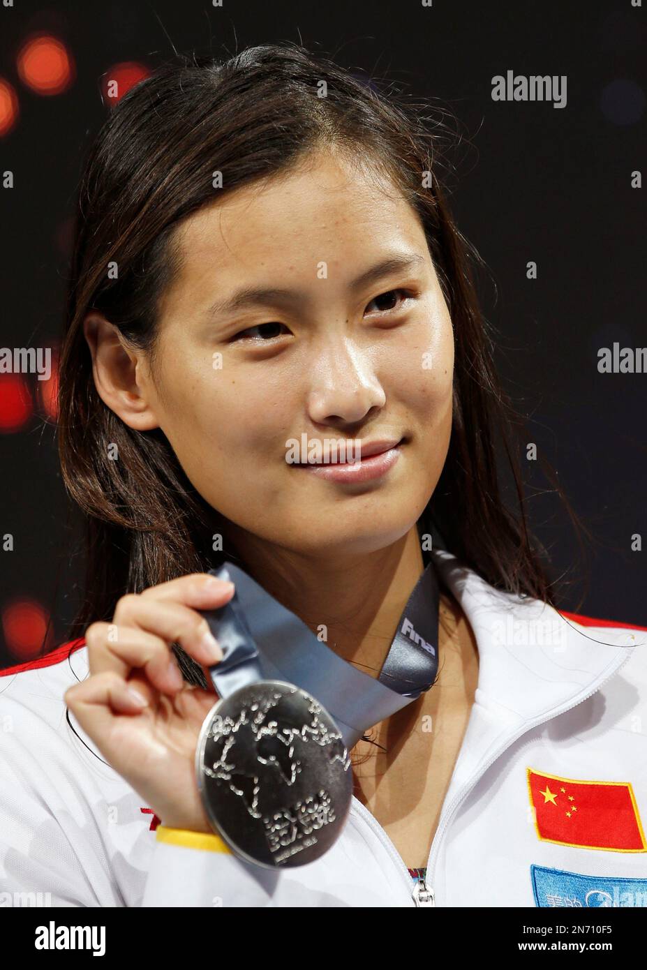 China's Lu Ying smiles as she holds the silver medal that she took in ...