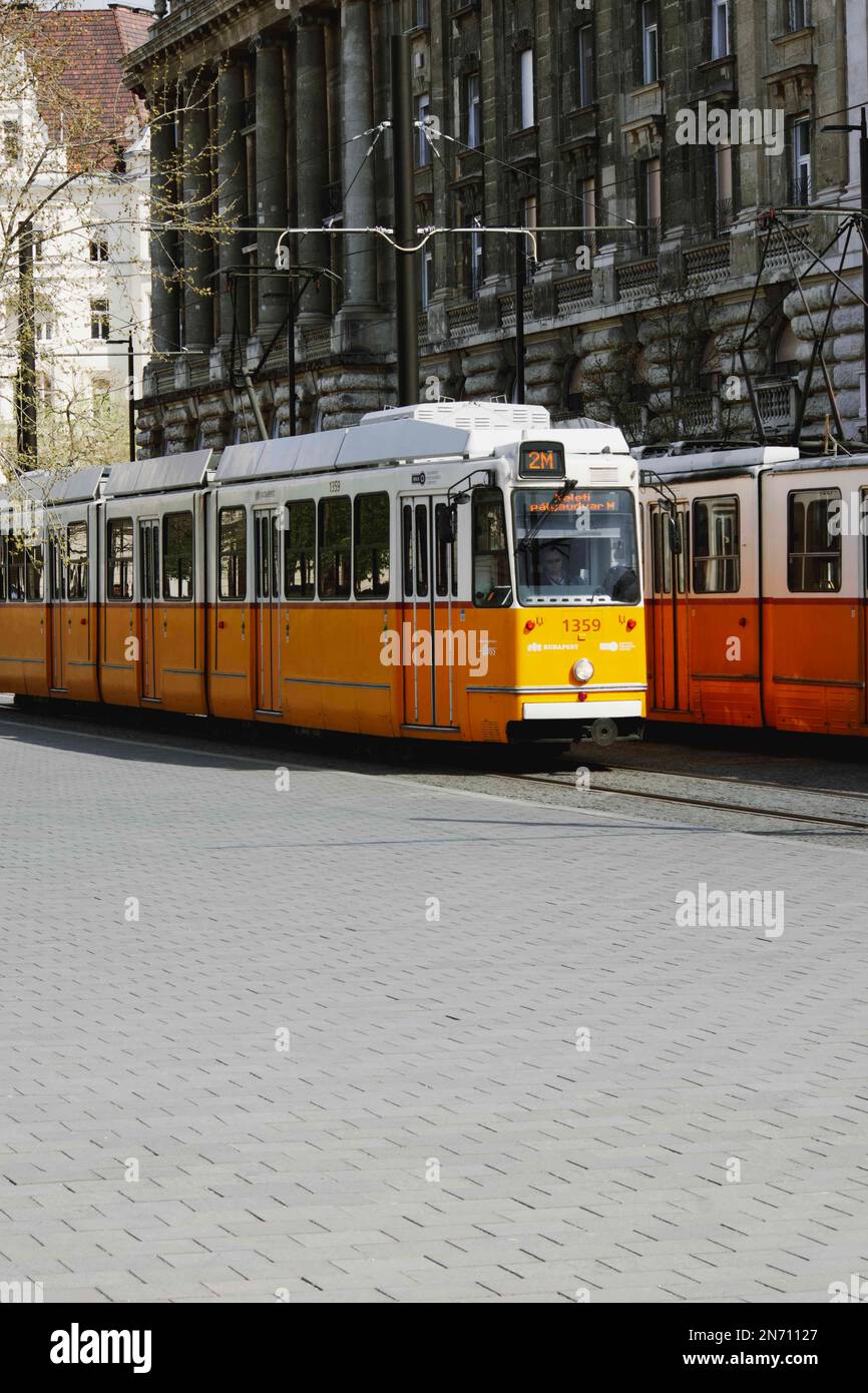 Two Budapest's yellow trams passing next to each other Stock Photo - Alamy