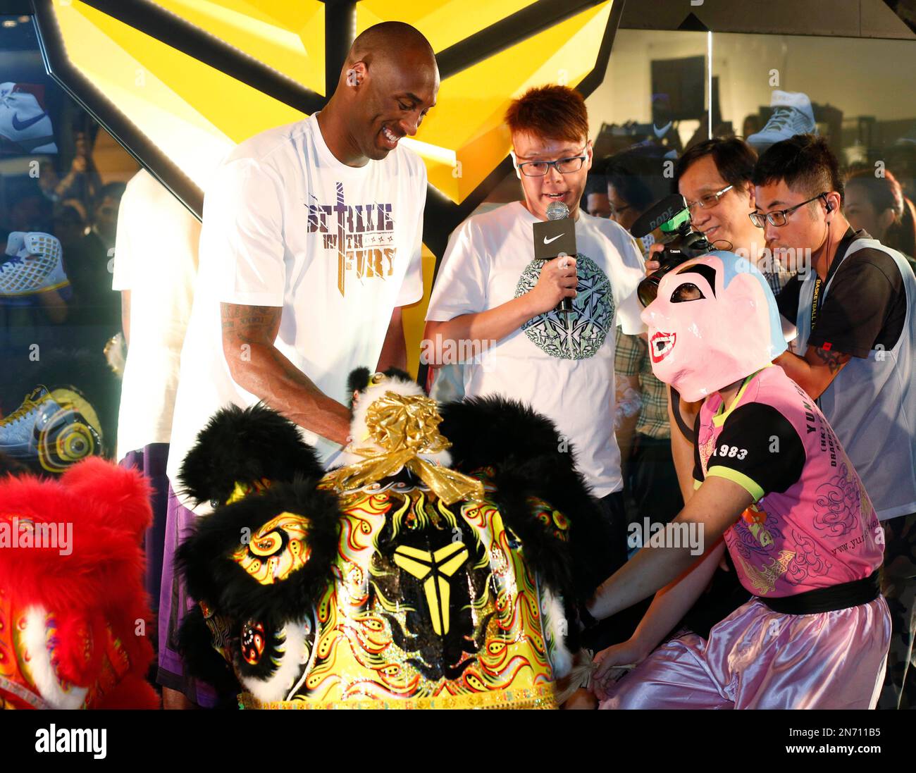 NBA player Kobe Bryant shares a light moment with performers of the ...