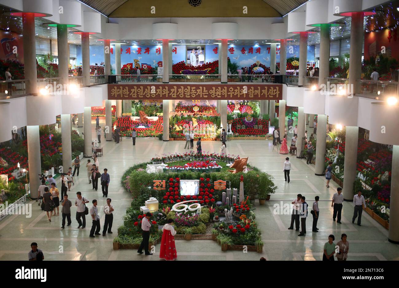 North Koreans gather at a display of Kimjongilia and Kimilsungia ...