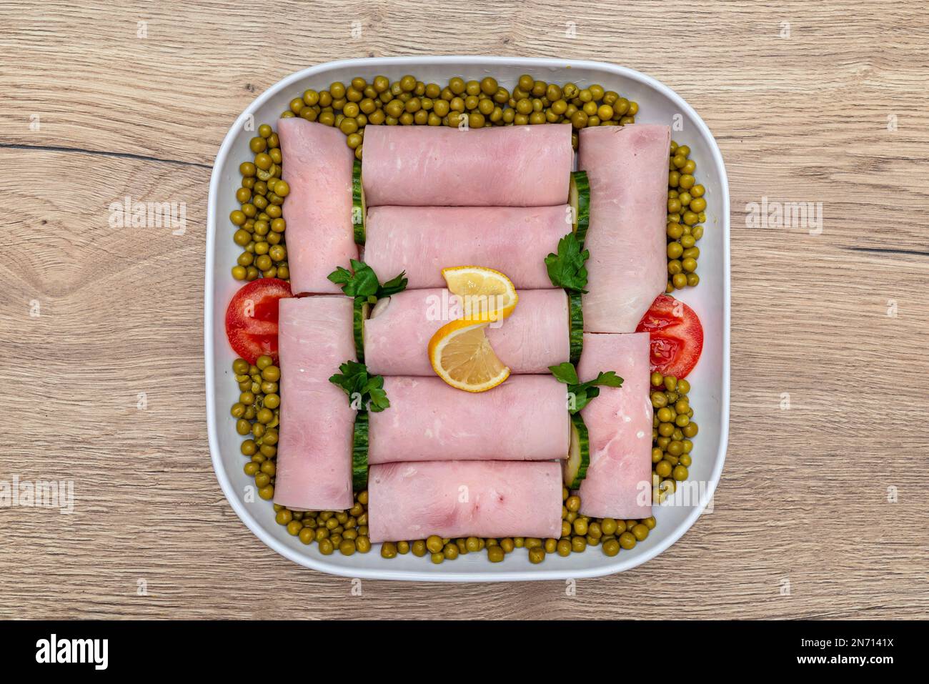Tinned meat wrapped with egg on a plate with vegetables, traditional ...