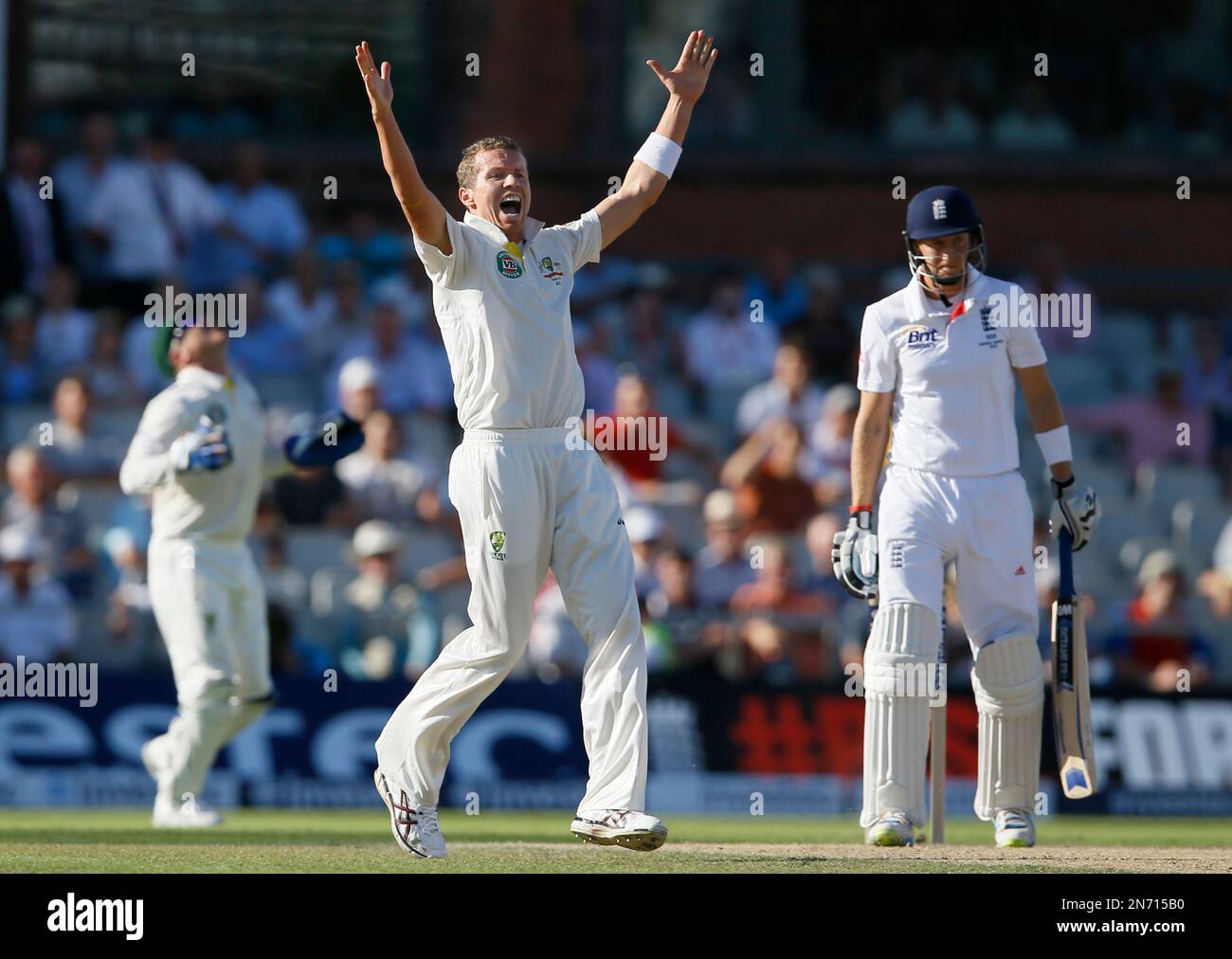Australia's Peter Siddle, centre, celebrates the wicket of England's ...