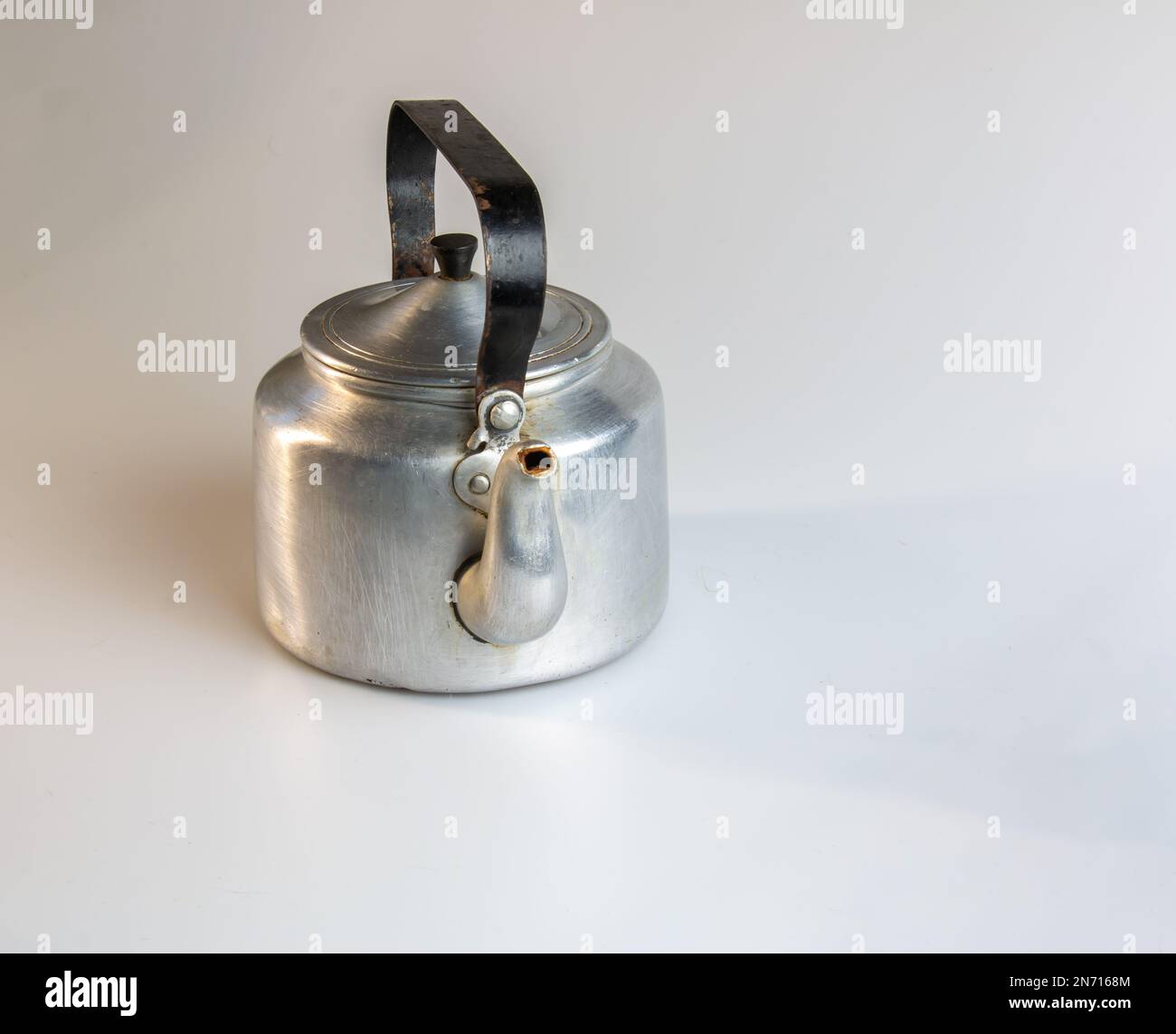 Old soldier's aluminum teapot from the Second World War on a white ...