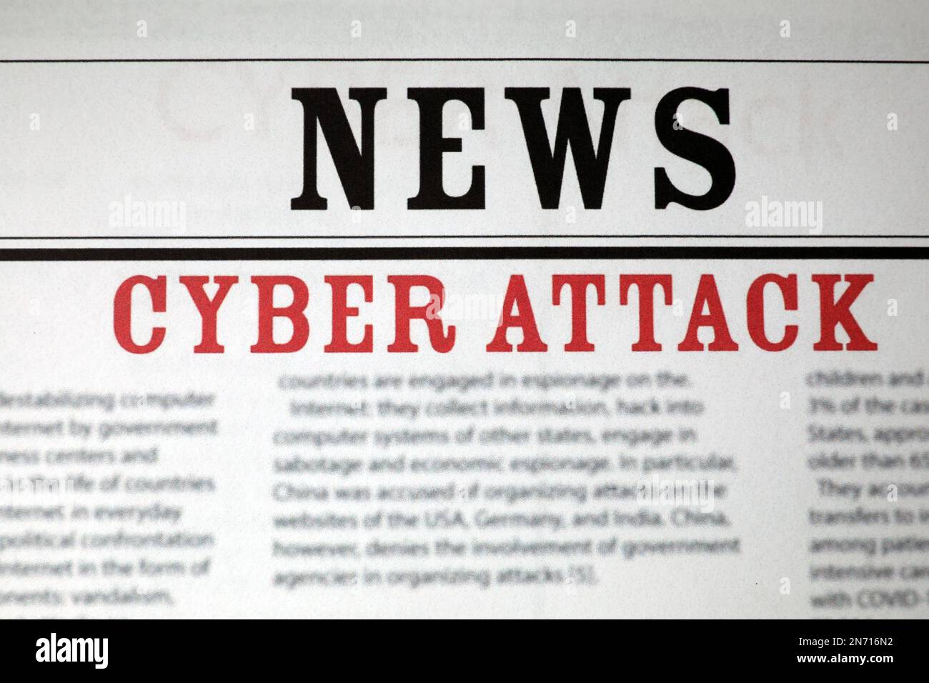 Top view of newspaper with headline CYBER ATTACK as background, closeup ...