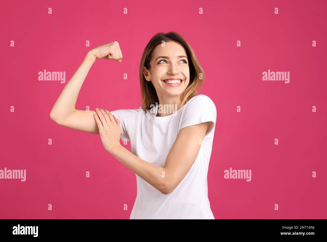 Strong woman as symbol of girl power on pink background. 8 March ...