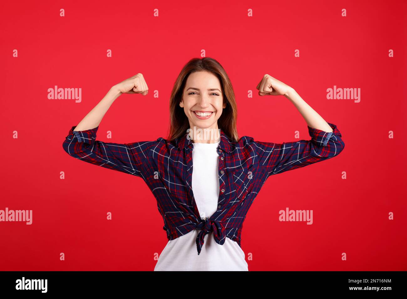 Strong woman as symbol of girl power on red background. 8 March concept ...