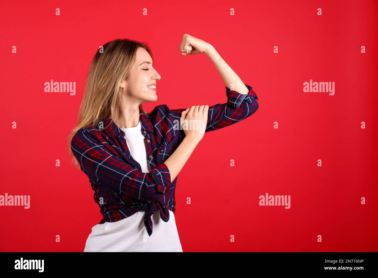 Strong woman as symbol of girl power on red background, space for text ...