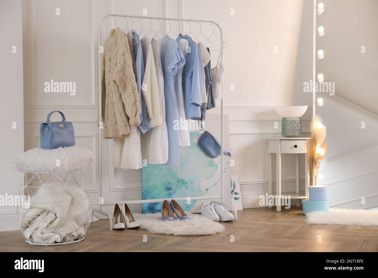 Rack with stylish clothes in modern dressing room Stock Photo - Alamy