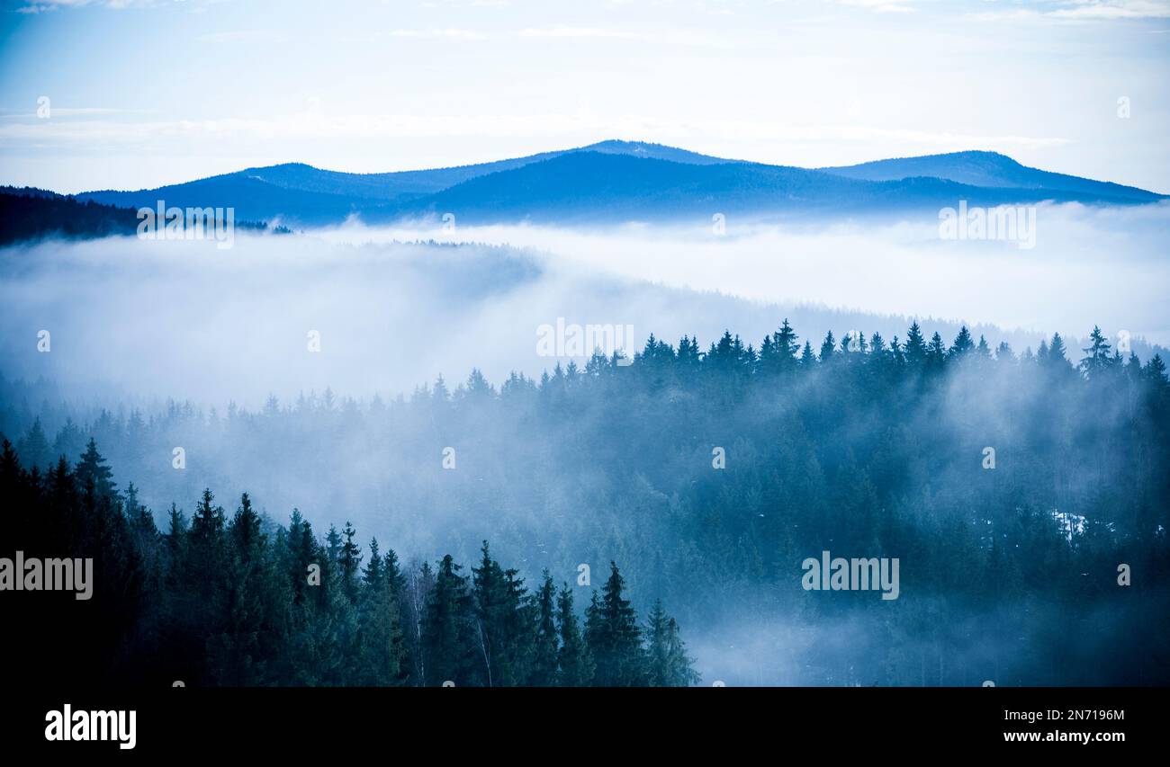 Clouds of fog in front of blue mountains Stock Photo - Alamy