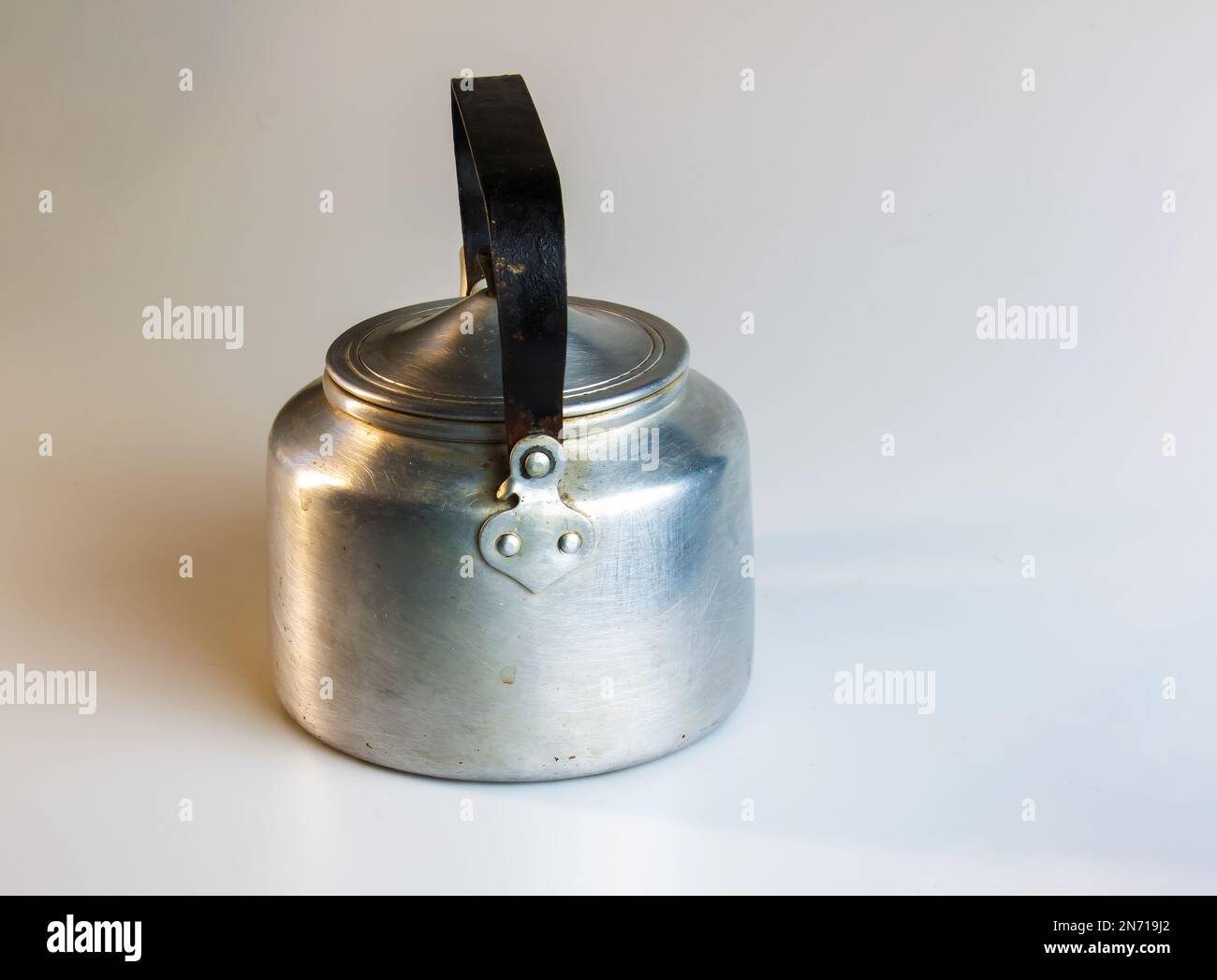 Old soldier's aluminum teapot from the Second World War on a white ...