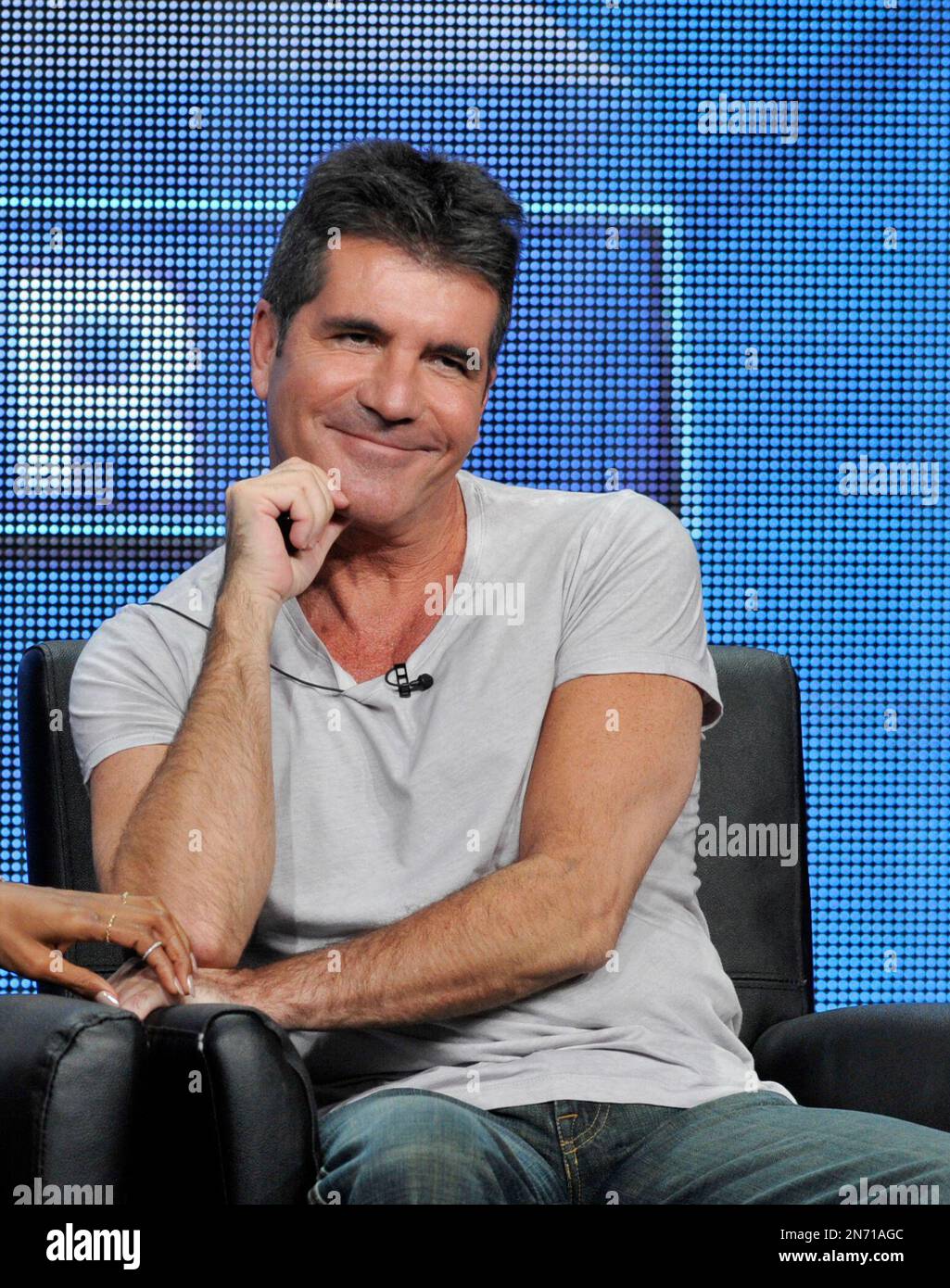 Simon Cowell, a judge on the FOX series "The X Factor," smiles from the ...