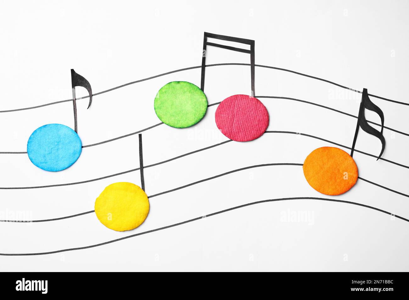 Dyed cotton pads as musical notes on white background, flat lay Stock ...