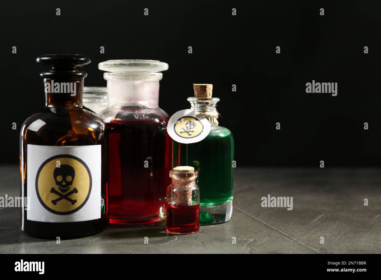 Bottles with poison on grey table. Space for text Stock Photo - Alamy