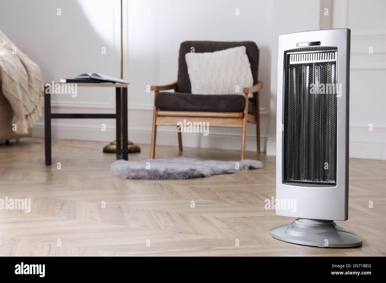 Modern electric heater on floor at home. Space for text Stock Photo - Alamy