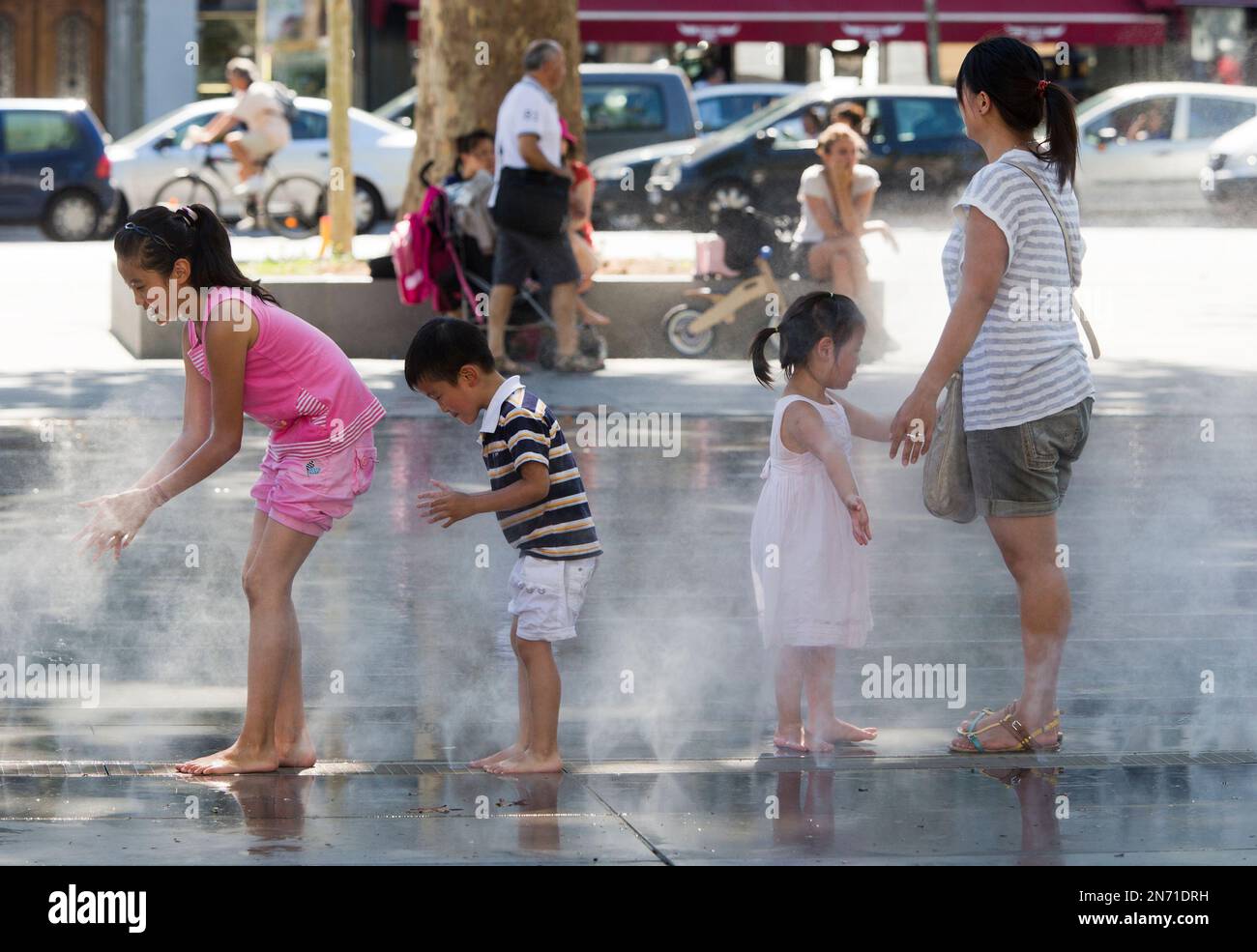 People Cool Down In Jets Of Water In Paris Thursday Aug 1 2013