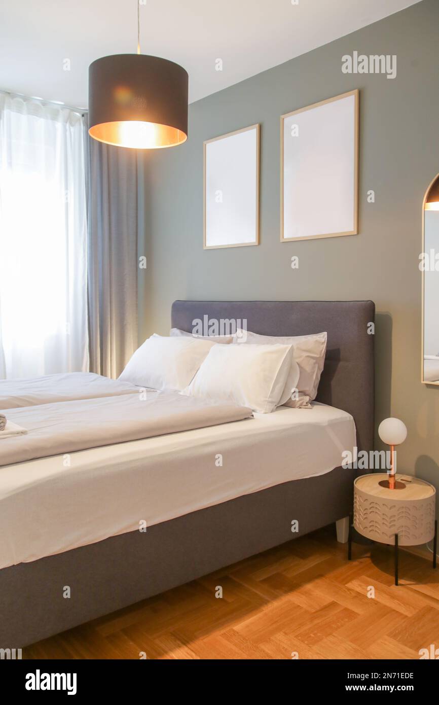 King size bed in simple and cozy bedroom Stock Photo - Alamy