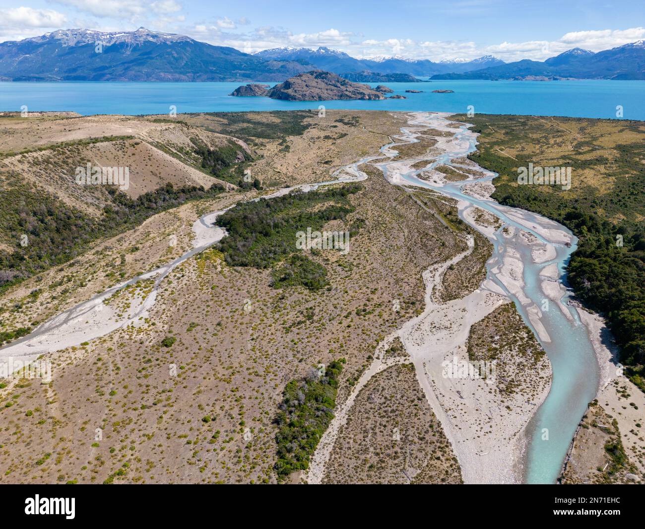 Aerial View of a creek flowing to the beautiful Lago General Carrera in ...